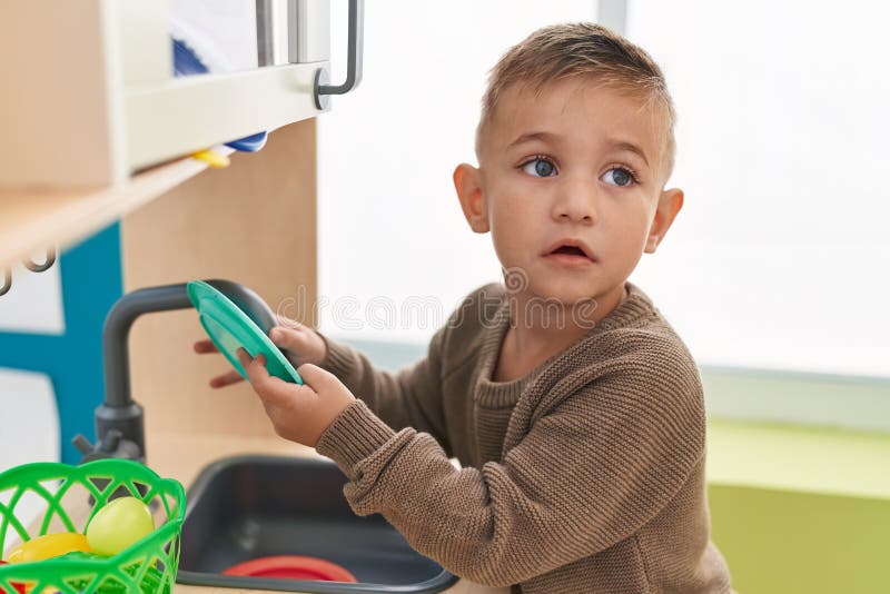 Adorable Hispanic Boy Playing with Play Kitchen Standing at ...