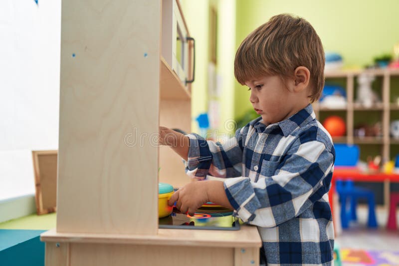 Adorable Hispanic Boy Playing with Play Kitchen Standing at ...
