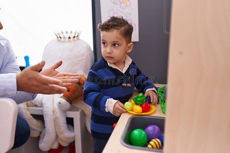 Adorable Hispanic Boy Playing with Play Kitchen Standing at ...