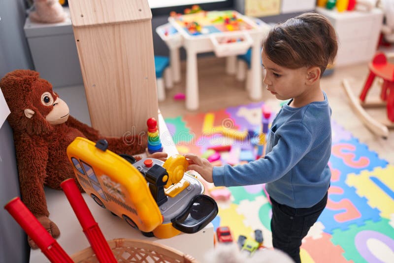 Adorable Hispanic Boy Playing with Tools Toy Standing at Kindergarten ...