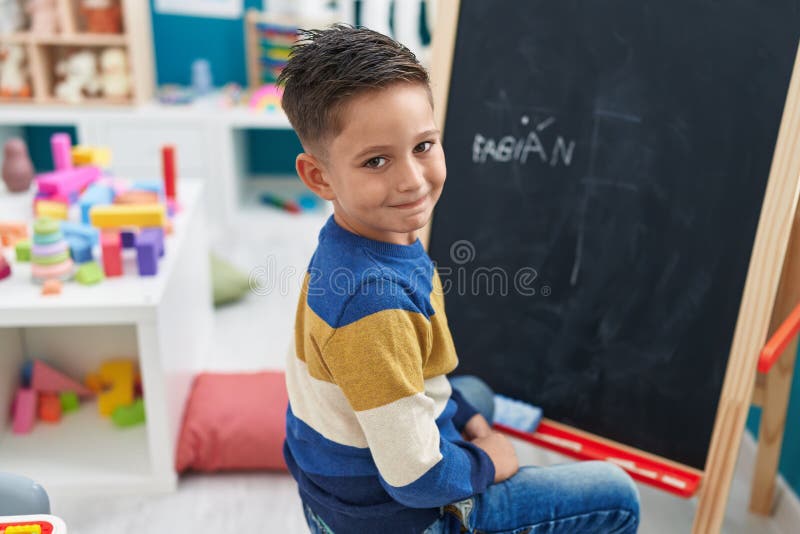 Adorable Hispanic Boy Preschool Student Drawing on Blackboard at ...