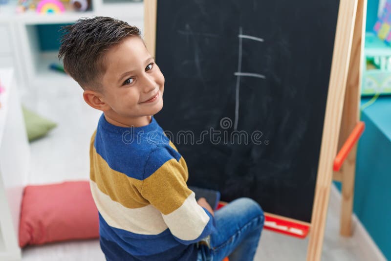 Adorable Hispanic Boy Preschool Student Drawing on Blackboard at ...