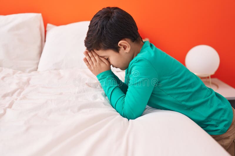 Adorable Hispanic Boy Sitting on Floor Praying at Bedroom Stock Photo ...