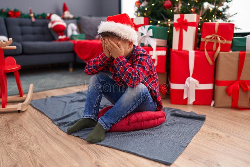 Adorable Hispanic Boy Sitting on Floor with Stressed Expression at Home ...