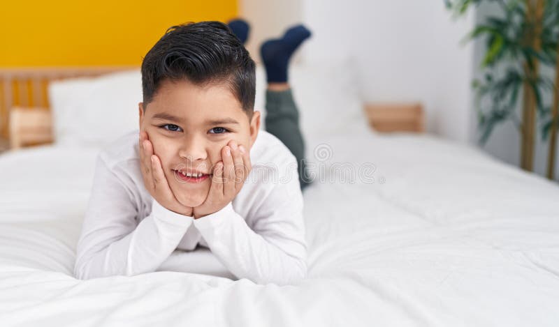 Adorable Hispanic Boy Smiling Confident Lying on Bed at Bedroom Stock ...