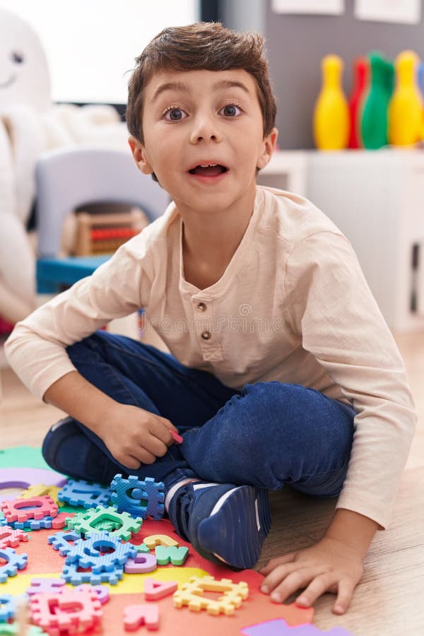 Adorable Hispanic Boy Smiling Confident Sitting on Floor at ...