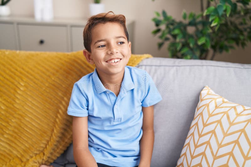 Adorable Hispanic Boy Smiling Confident Sitting on Sofa at Home Stock ...