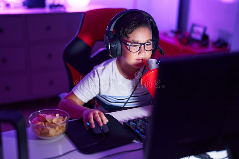 Adorable Hispanic Boy Streamer Playing Video Game Drinking Beverage at ...