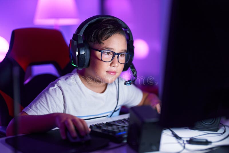 Adorable Hispanic Boy Streamer Playing Video Game Using Computer at ...
