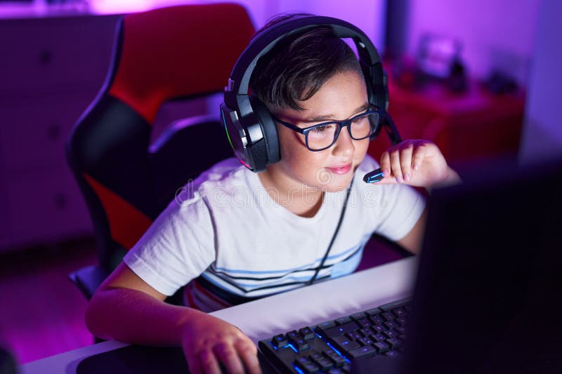 Adorable Hispanic Boy Streamer Playing Video Game Using Computer at ...