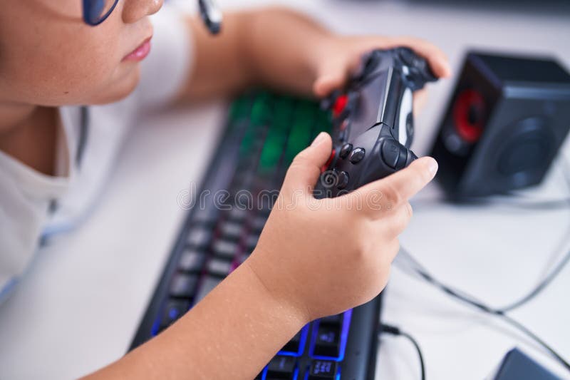 Adorable Hispanic Boy Streamer Playing Video Game Using Joystick at ...