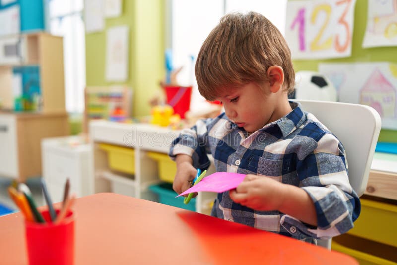 Adorable Hispanic Boy Student Cutting Paper at Kindergarten Stock Photo ...