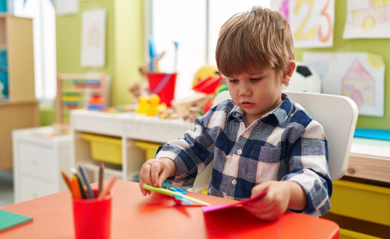 Adorable Hispanic Boy Student Cutting Paper at Kindergarten Stock Photo ...