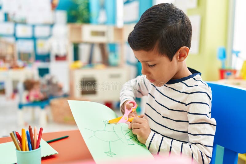 Adorable Hispanic Boy Student Cutting Paper at Kindergarten Stock Image ...