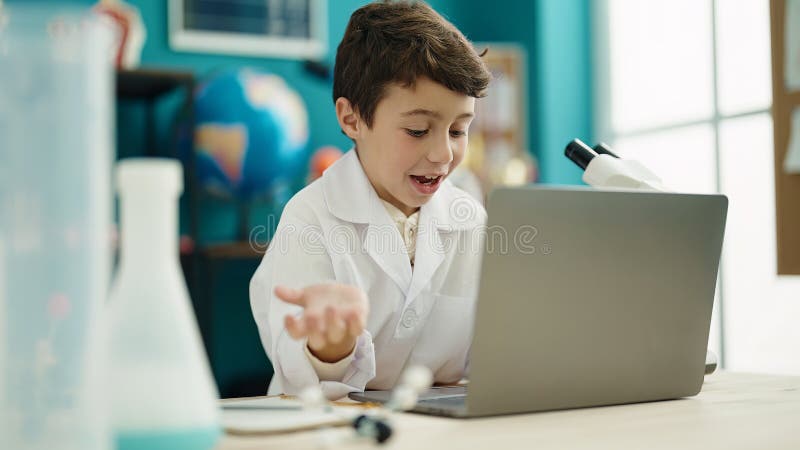 Adorable Hispanic Boy Student Having Video Call at Laboratory Classroom ...