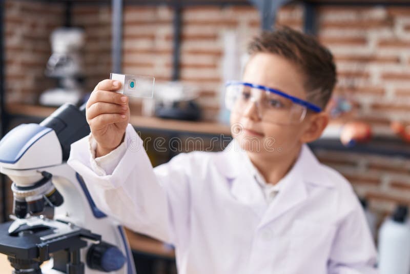 Adorable Hispanic Boy Student Looking Sample at Laboratory Classroom ...