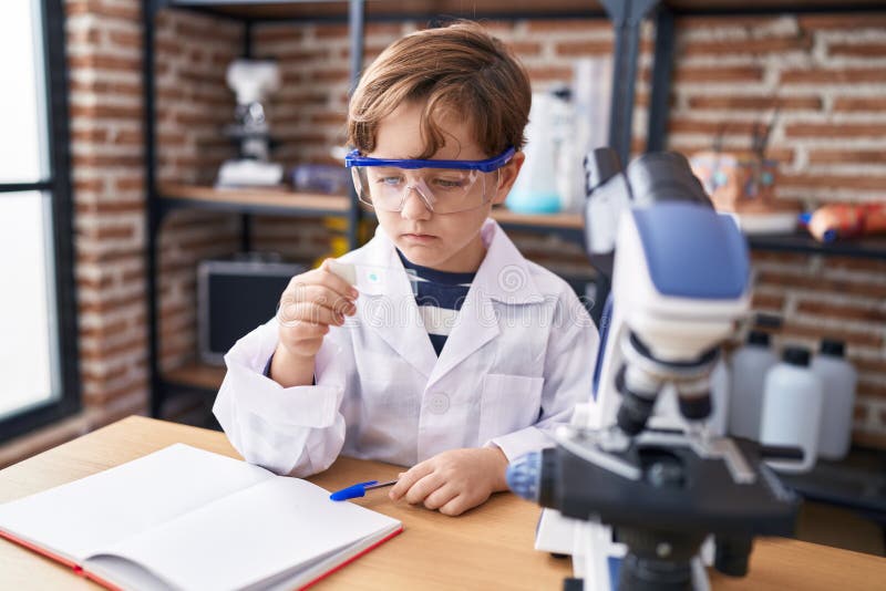 Adorable Hispanic Boy Student Looking Sample at Laboratory Classroom ...