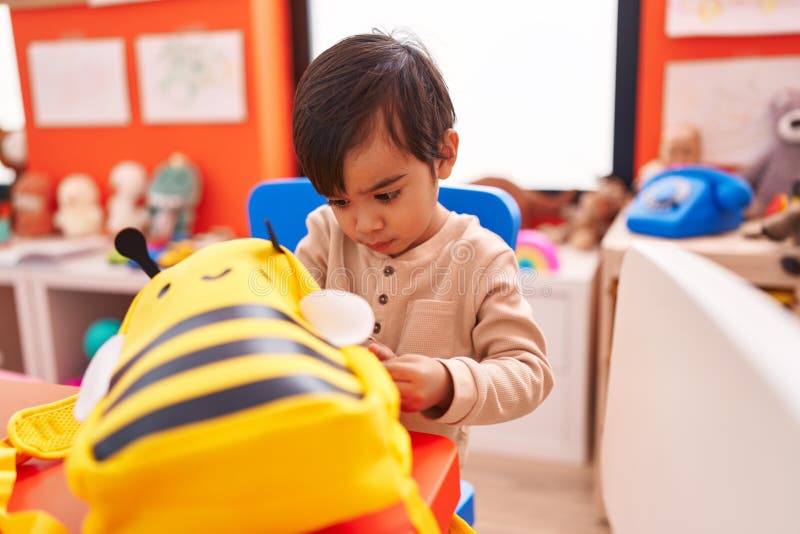 Adorable Hispanic Boy Student Opening Backpack Sitting on Table at ...