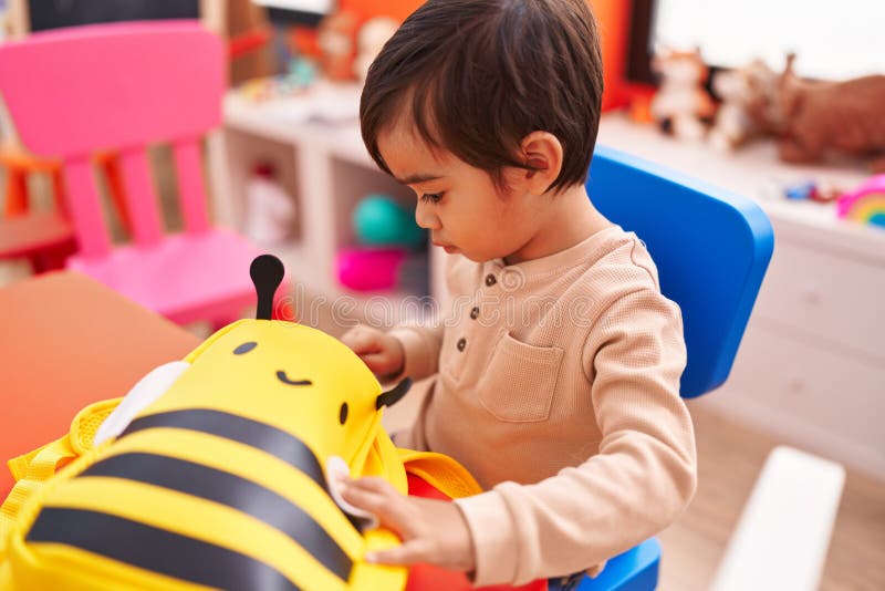 Adorable Hispanic Boy Student Opening Backpack Sitting on Table at ...
