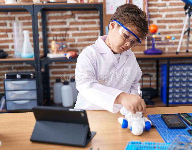 Adorable Hispanic Boy Student Repairing Robot at Laboratory Classroom ...