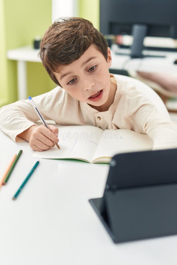 Adorable Hispanic Boy Student Sitting on Table Doing Homework at ...