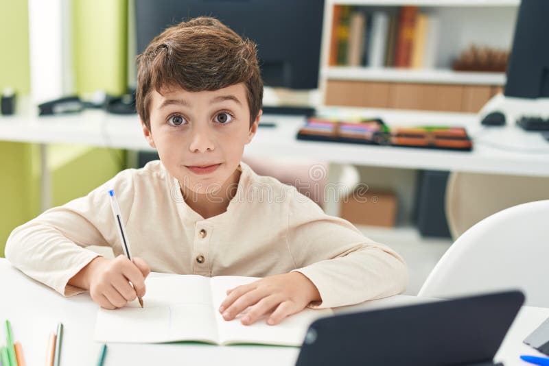 Adorable Hispanic Boy Student Sitting on Table Doing Homework at ...