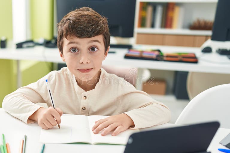 Adorable Hispanic Boy Student Sitting on Table Doing Homework at ...