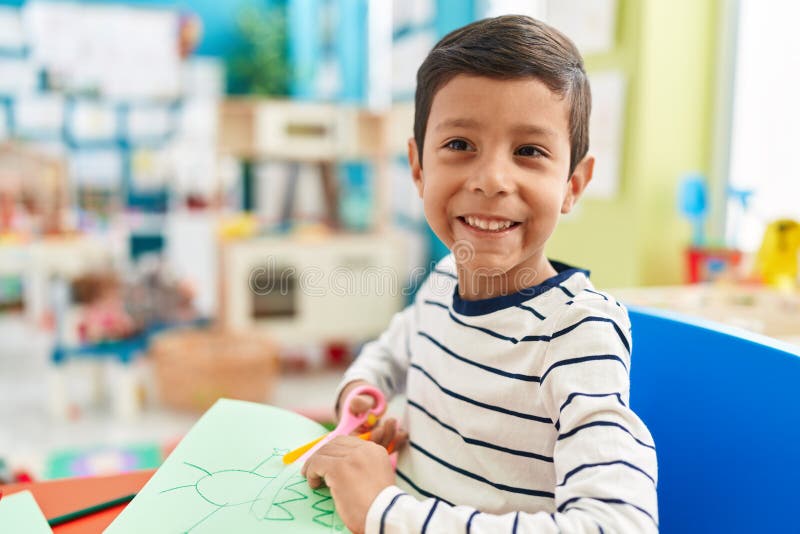 Adorable Hispanic Boy Student Smiling Confident Cutting Paper at ...
