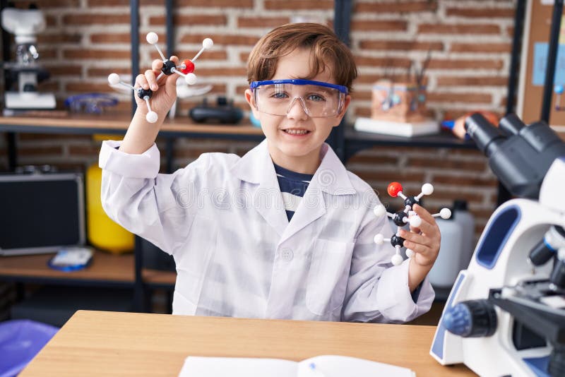 Adorable Hispanic Boy Student Smiling Confident Holding Molecules at ...