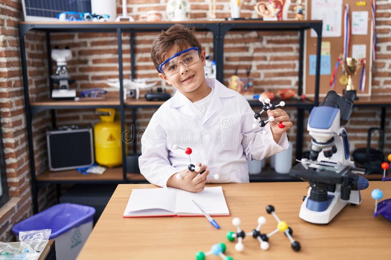 Adorable Hispanic Boy Student Smiling Confident Holding Molecules at ...