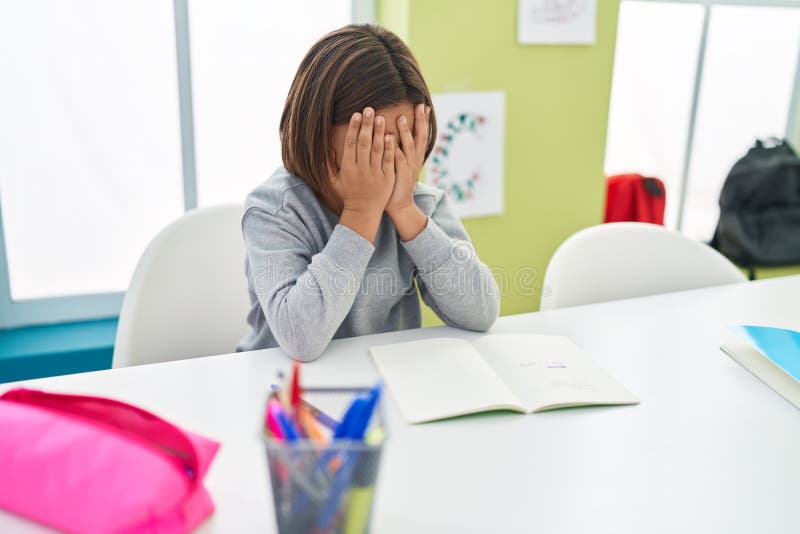 Adorable Hispanic Boy Student Studying with Stressed Expression at ...