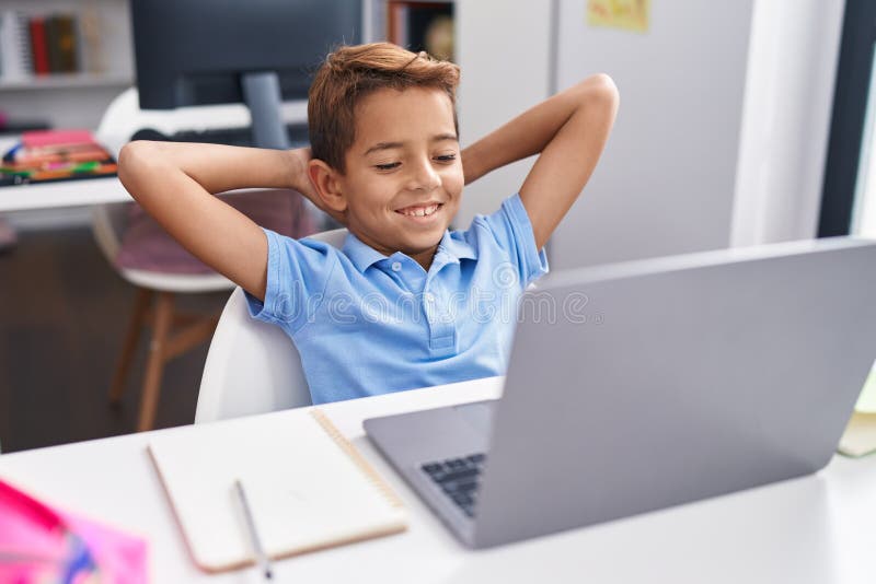 Adorable Hispanic Boy Student Using Computer Relaxed with Hands on Head ...