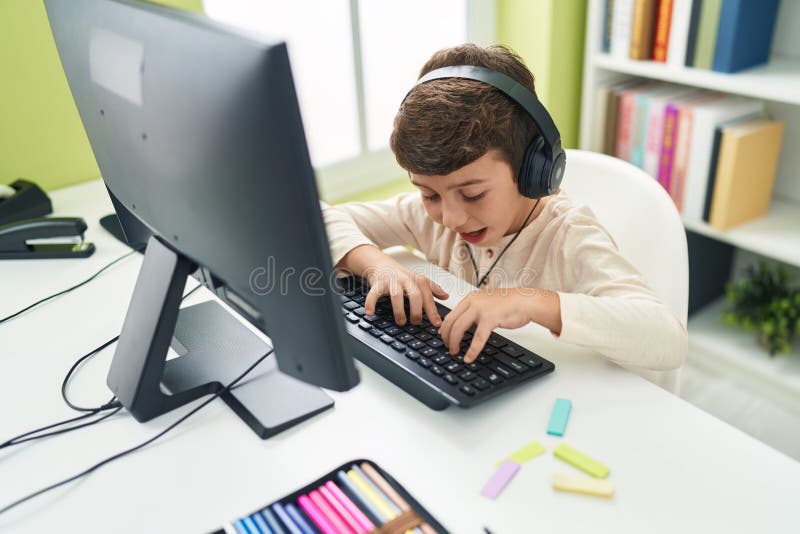 Adorable Hispanic Boy Student Using Computer Sitting on Table at ...