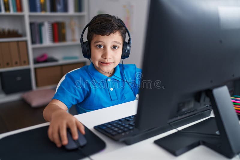 Adorable Hispanic Boy Student Using Computer Sitting on Table at ...
