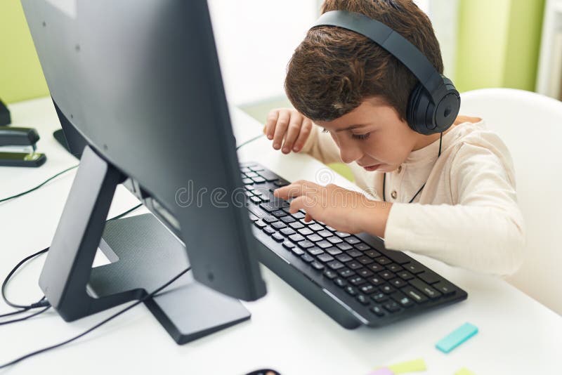 Adorable Hispanic Boy Student Using Computer Sitting on Table at ...