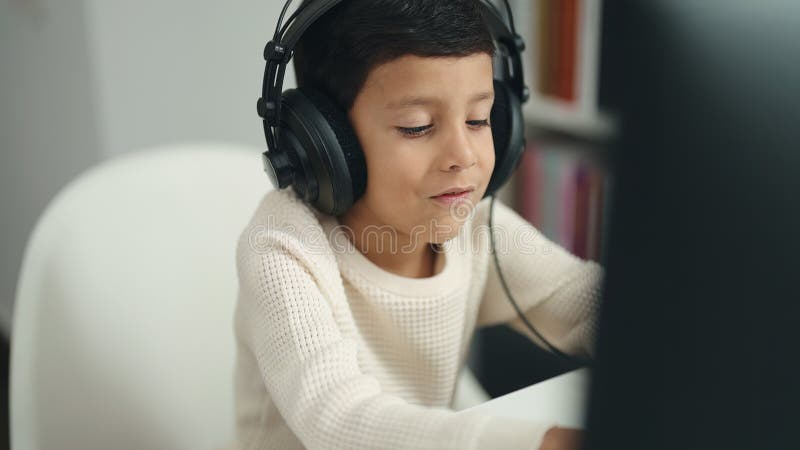 Adorable Hispanic Boy Student Using Computer Sitting on Table at ...