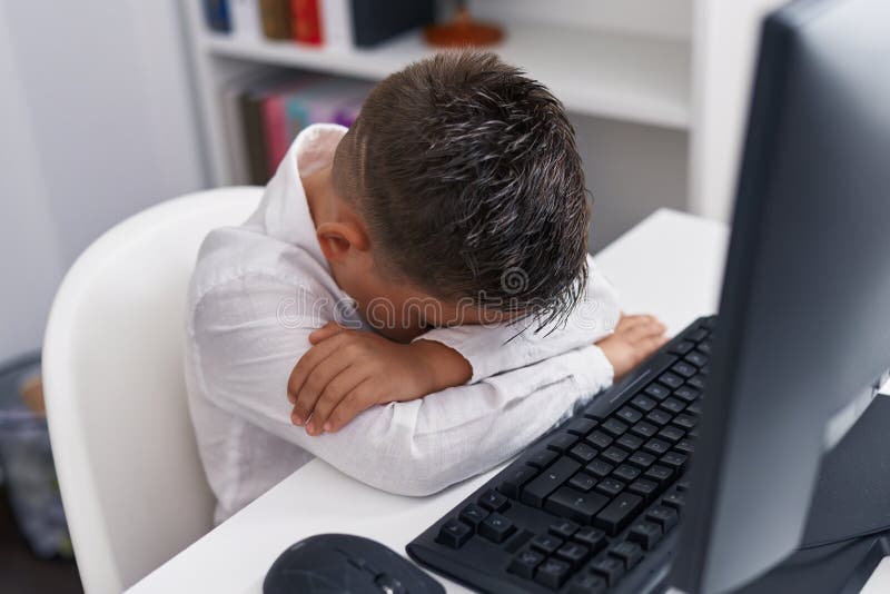 Adorable Hispanic Boy Student Using Computer with Stressed Expression ...