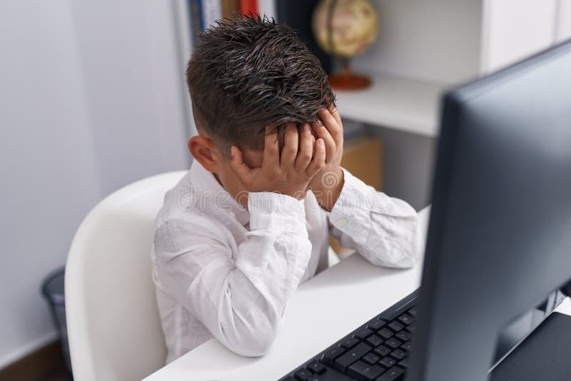 Adorable Hispanic Boy Student Using Computer with Stressed Expression ...