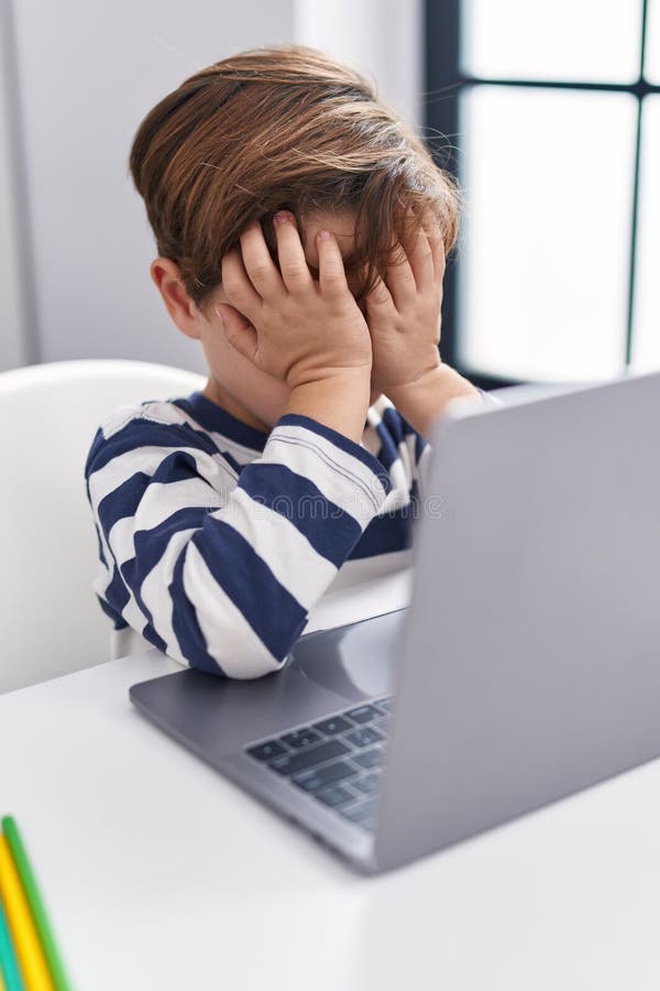 Adorable Hispanic Boy Student Using Computer with Stressed Expression ...