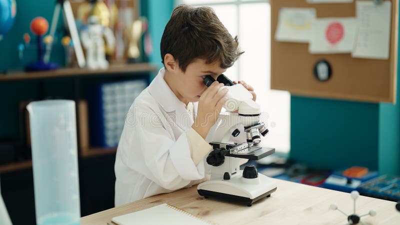 Adorable Hispanic Boy Student Using Microscope at Laboratory Classroom ...