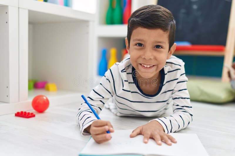Adorable Hispanic Boy Student Writing on Notebook at Kindergarten Stock ...