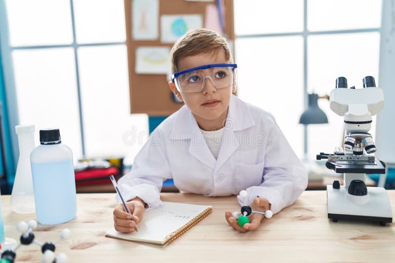 Adorable Hispanic Boy Student Smiling Confident Pouring Liquid on Test ...