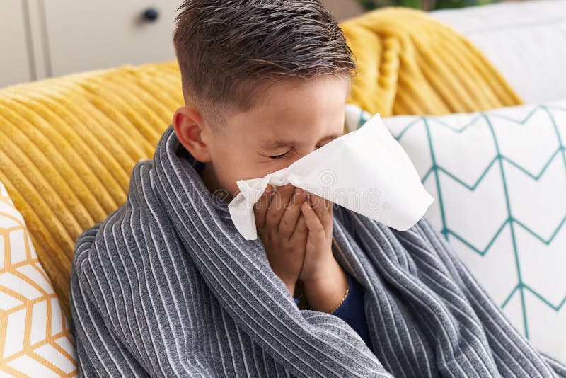 Adorable Hispanic Boy Using Napkin Sitting on Sofa at Home Stock Image ...
