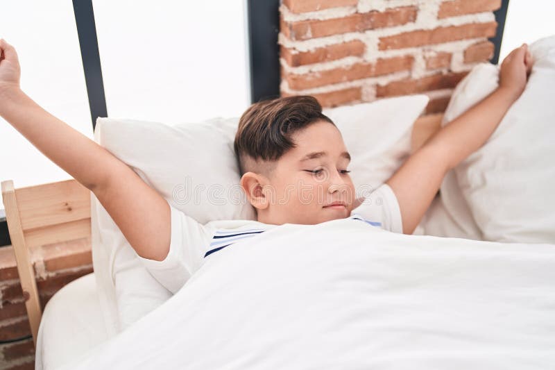 Adorable Hispanic Boy Waking Up Stretching Arms at Bedroom Stock Image ...