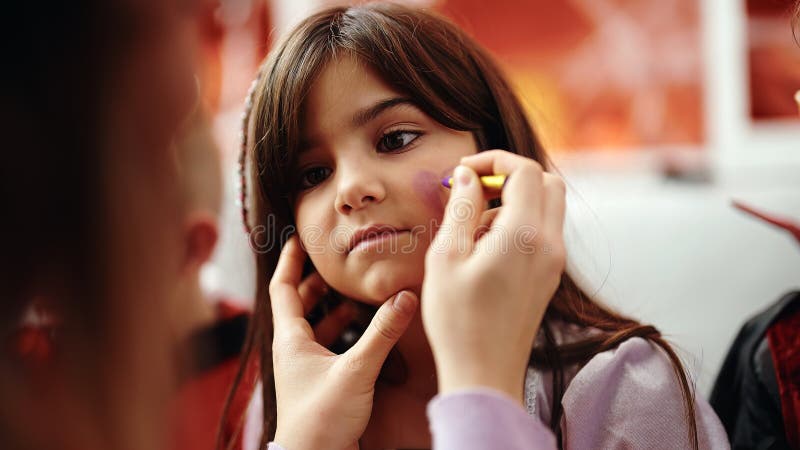 Adorable Hispanic Girl Applying Make Up on Face at Home Stock Photo ...