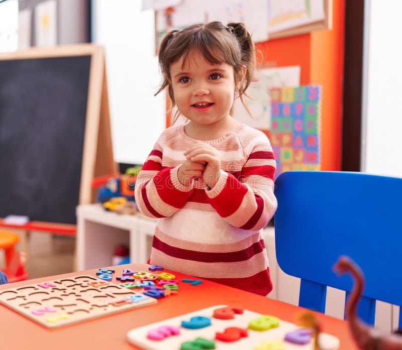 Adorable Hispanic Girl Playing with Maths Puzzle Game Standing at ...