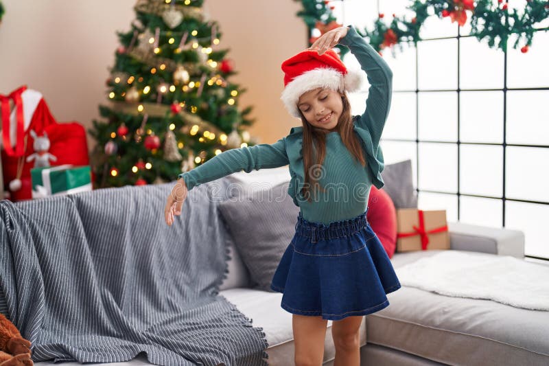 Adorable Hispanic Girl Standing by Christmas Tree Dancing at Home Stock ...