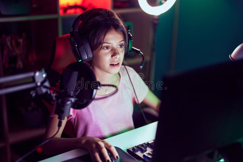 Adorable Hispanic Girl Streamer Playing Video Game Using Computer at ...