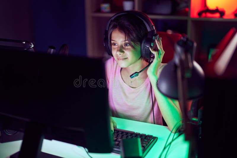 Adorable Hispanic Girl Streamer Playing Video Game Using Computer at ...