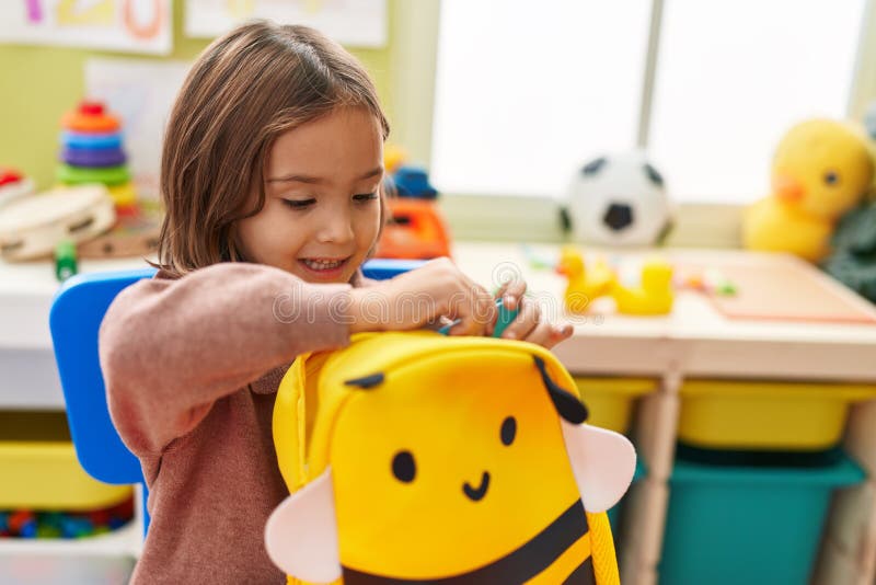 Adorable Hispanic Girl Student Closing Backpack Sitting on Table at ...